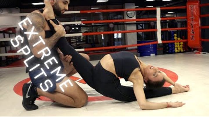 Extreme splits. Gymnastic skills. Stretching on the oversplits with a partner